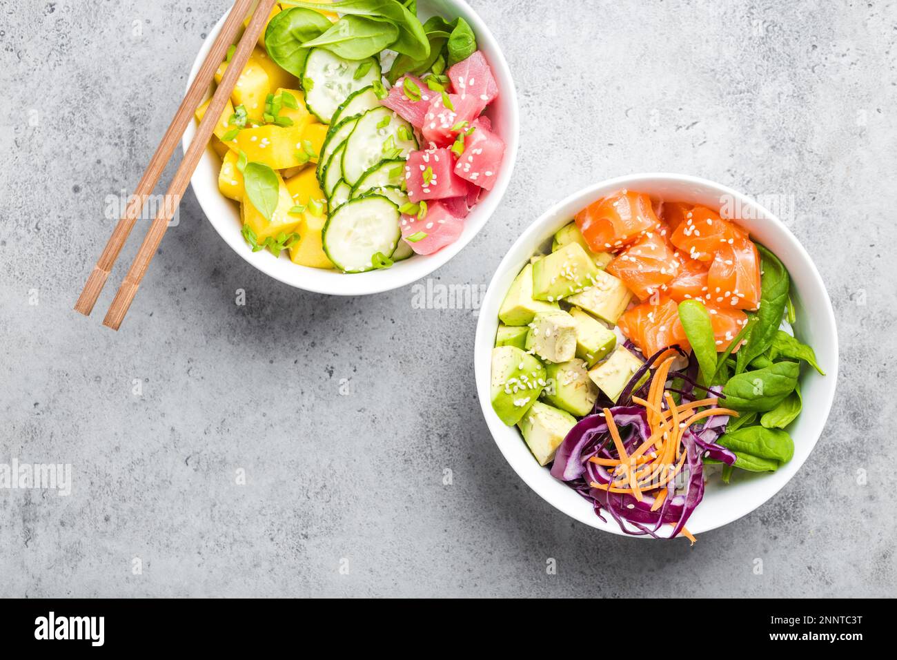 Top view of two assorted poke bowls with fresh raw tuna, salmon ...