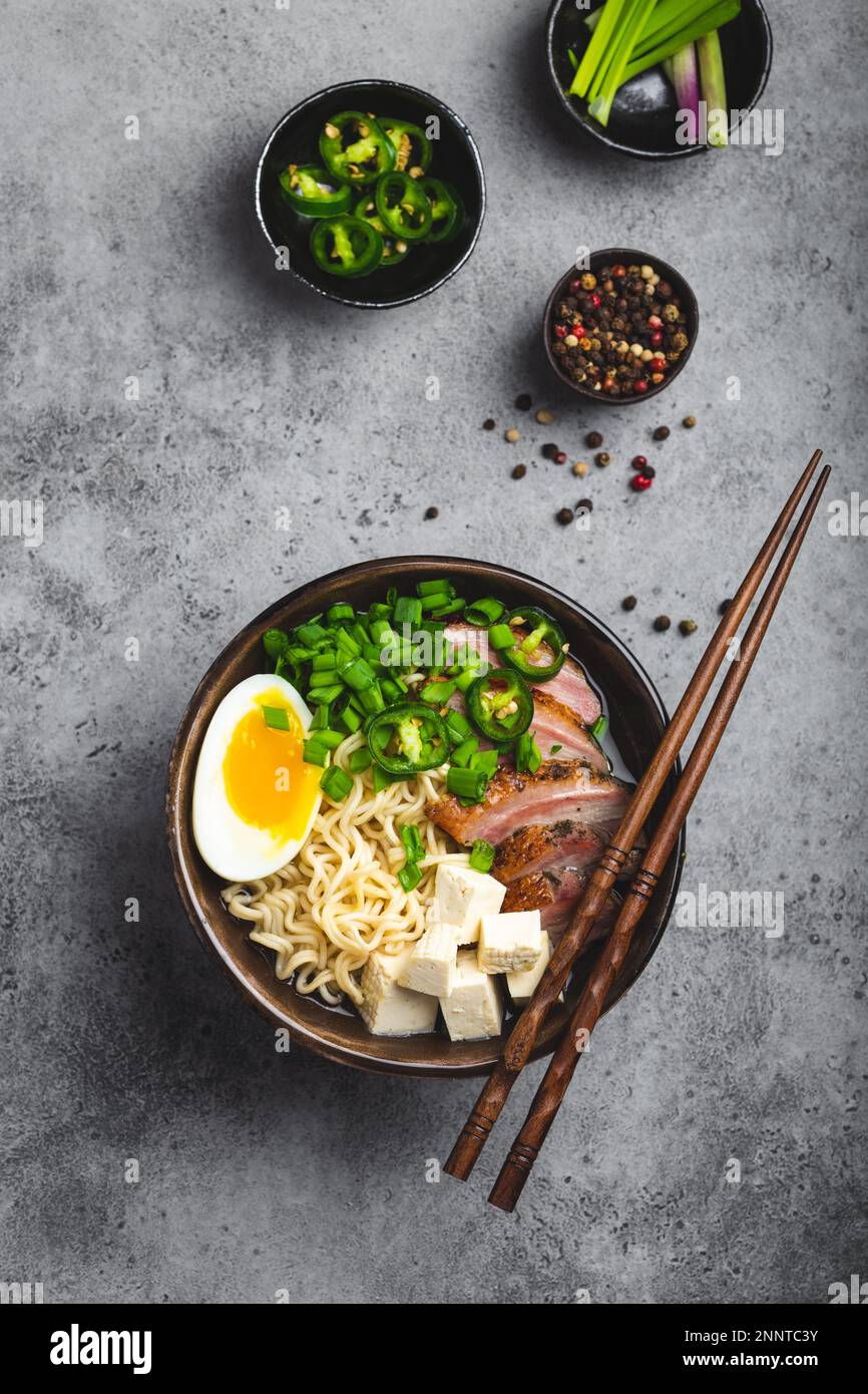 Delicious Asian noodle soup ramen in bowl with meat broth, tofu, sliced ...