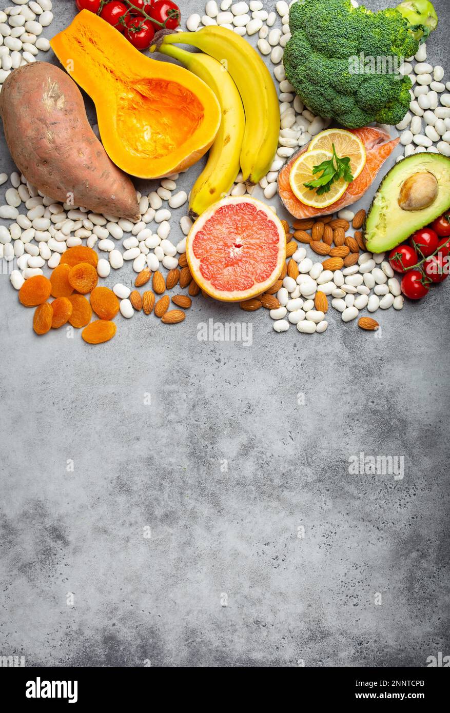 Vegetables, fruit and foods containing potassium, stone background, top ...
