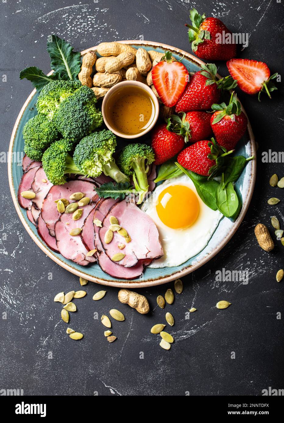 Ketogenic low carbs diet concept, top view. Plate on stone black ...