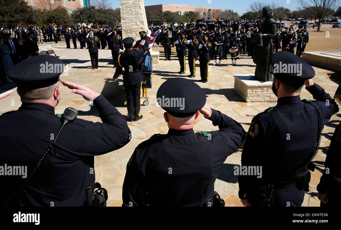 Dallas Police salute as the U.S. flag is removed from the casket ...