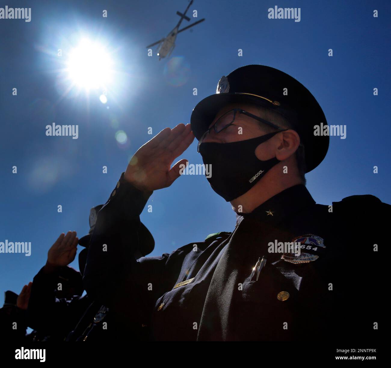 The Dallas Police helicopter makes a fly by over during the funeral ...