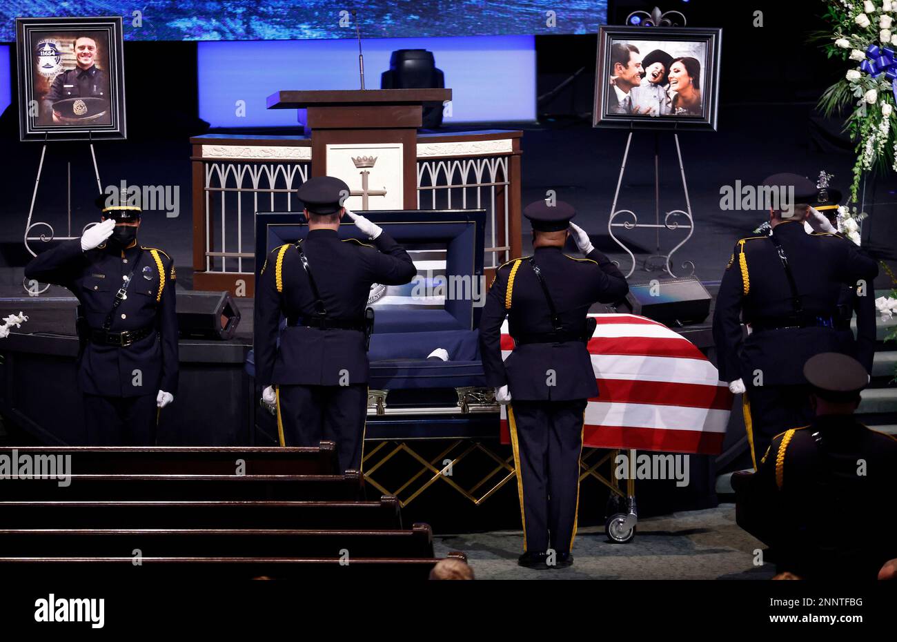 Members of the Dallas Police Honor Guard salute the open casket of ...