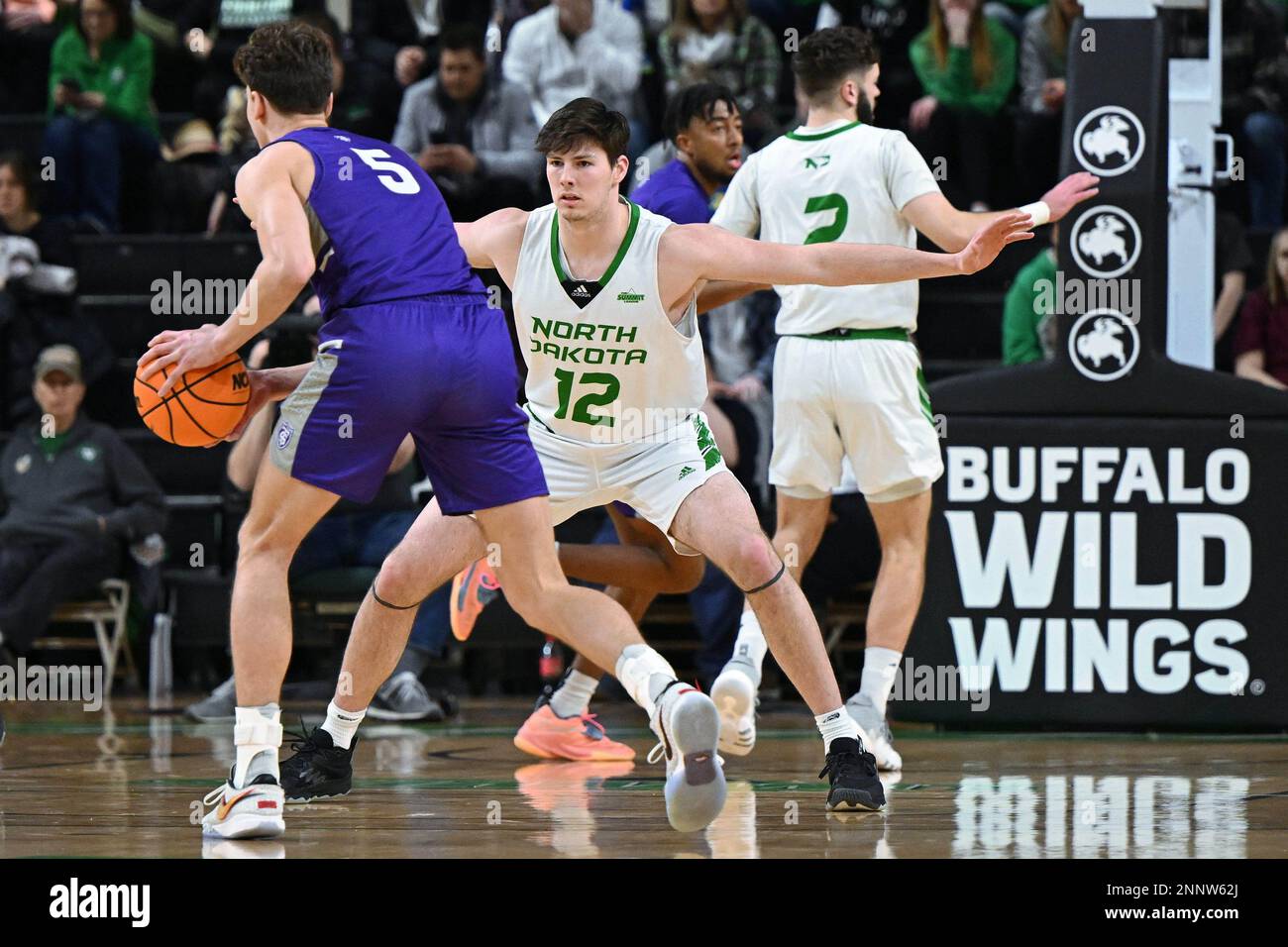 North Dakota Fighting Hawks forward Brian Mathews (12) guards St. Thomas - Minnesota Tommies ...