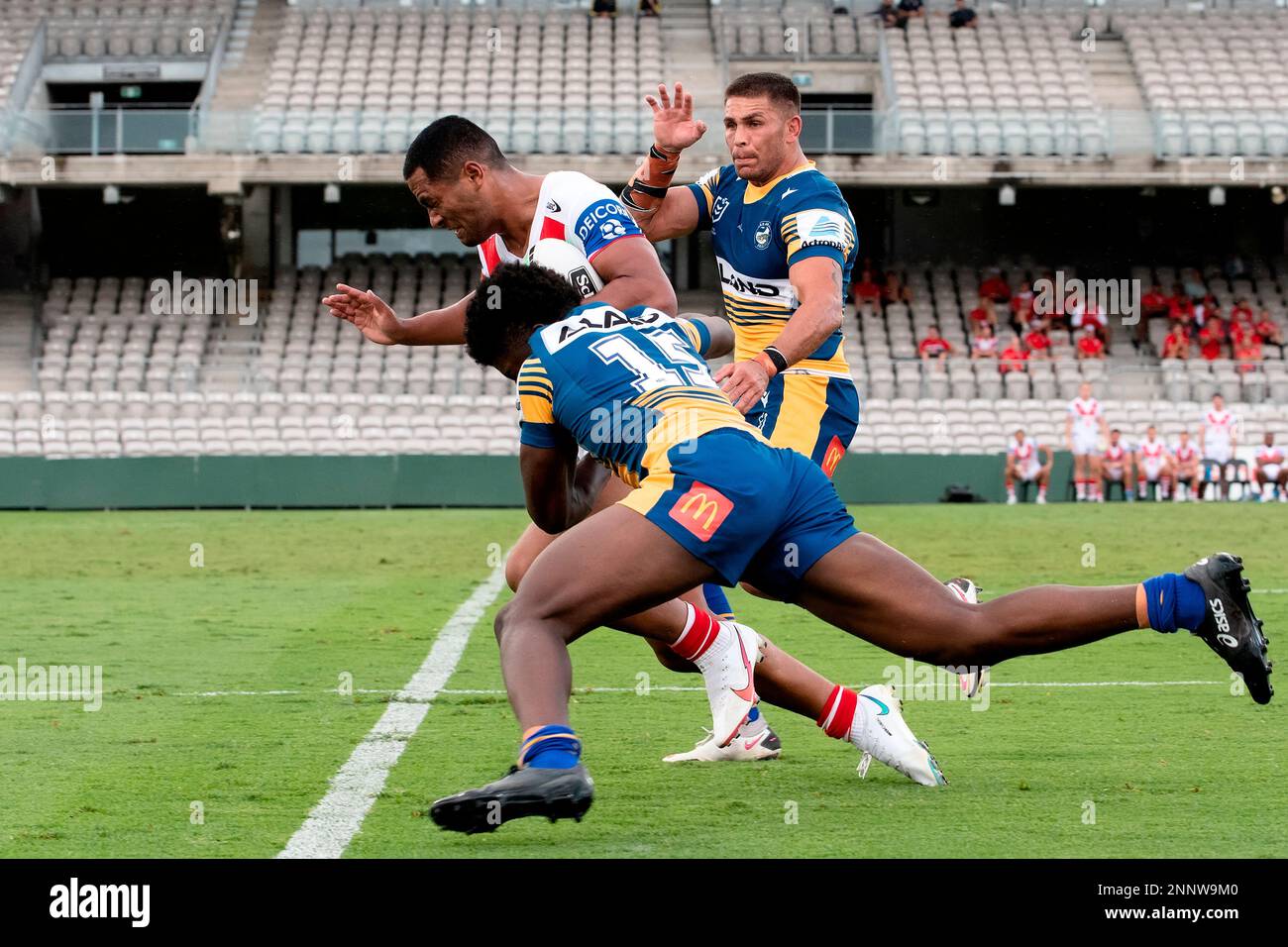 SYDNEY, AUSTRALIA - FEBRUARY 18: Matt Feagai of the Dragons is tackled by Matt Komolafe of the ...