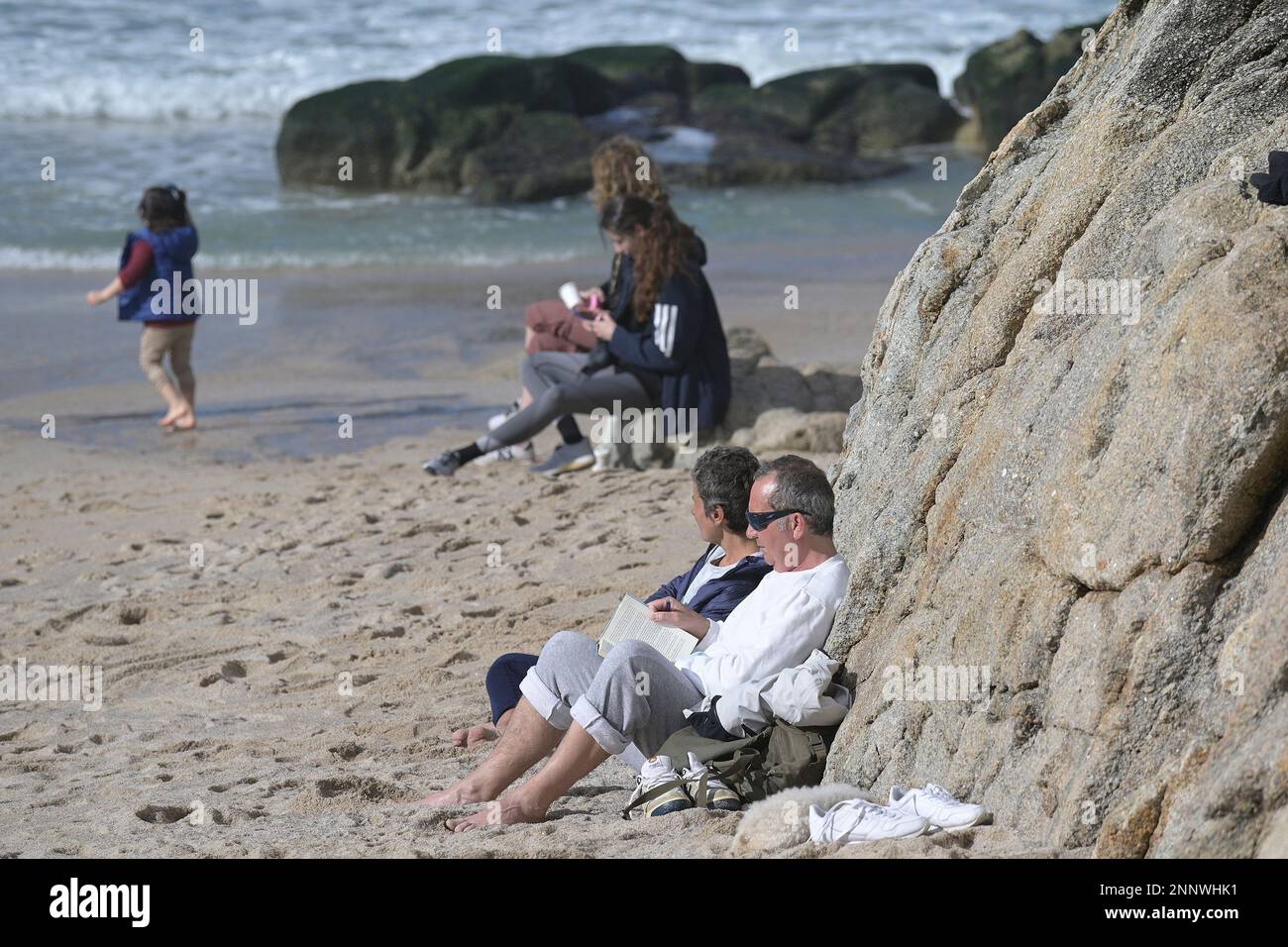 A Several people enjoy an early spring day with temperatures of 20ºC ...
