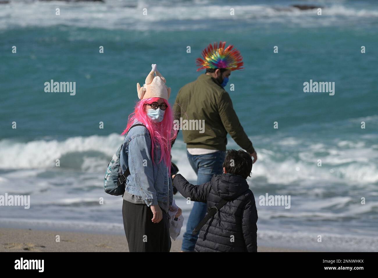 Several people with Carnival decorations enjoy an early spring day with ...