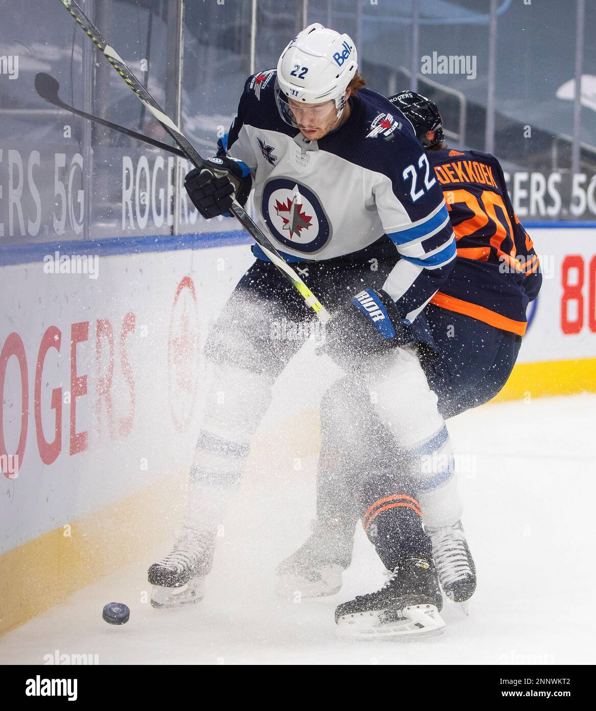Edmonton Oilers' Slater Koekkoek (20) checks Winnipeg Jets' Mason ...
