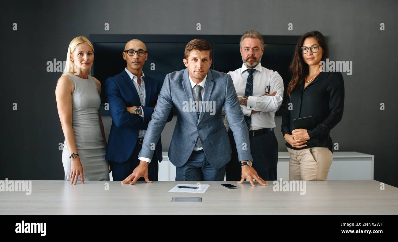 business man standing with a team of male and female corporate ...