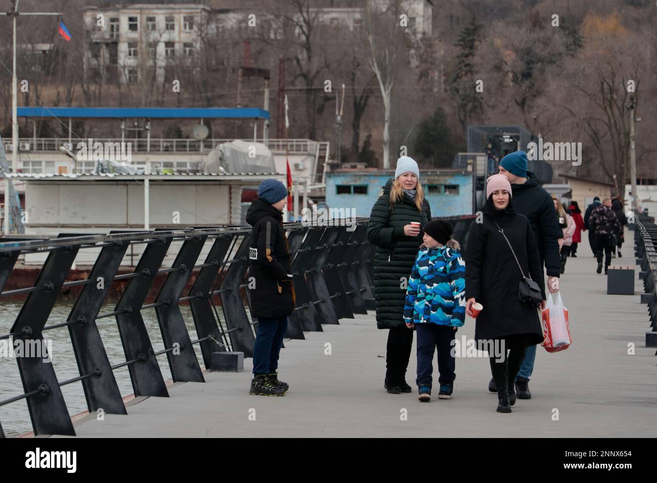 People walk along the embankment of the Sea of Azov after the first ...