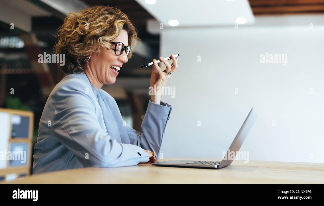 business woman smiles as she talks to an associate on a mobile phone ...