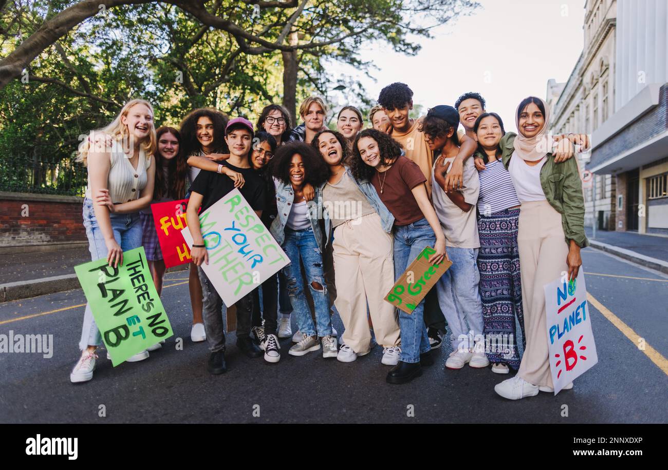 Group of diverse youth activists smiling cheerfully while standing ... Group of diverse youth activists smiling cheerfully while standing ...