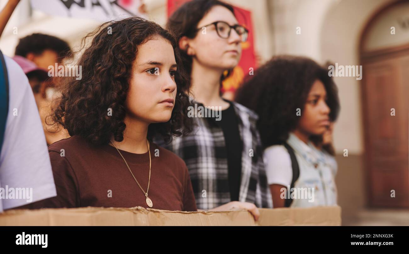 Group of multicultural protestors marching against war and violence in ...
