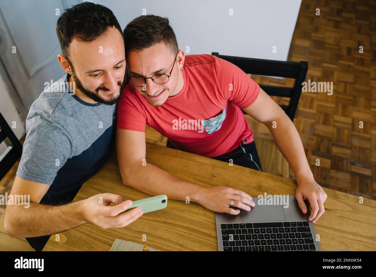 Two men taking a picture with his mobile phone Stock Photo - Alamy