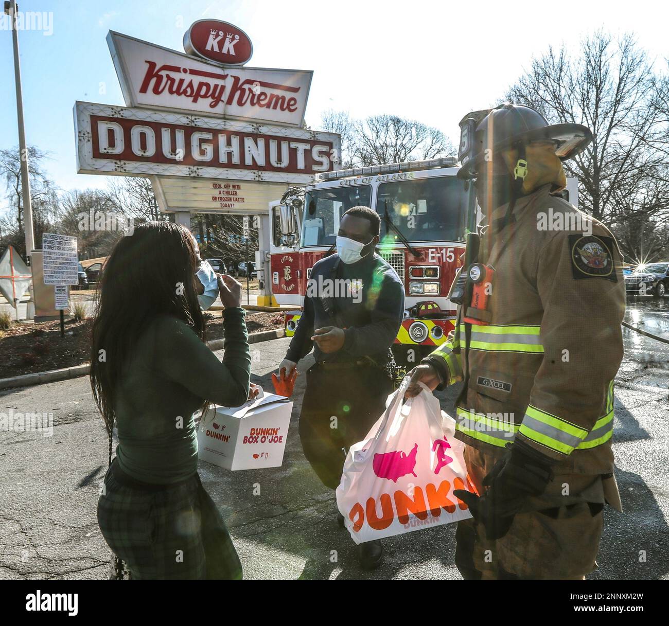 Neighborhood resident Jasmine Rozier, left, delivers Dunkin donuts to ...