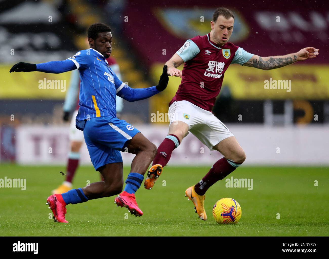 Brighton's Yves Bissouma, left, challenges Burnley's Ashley Barnes ...