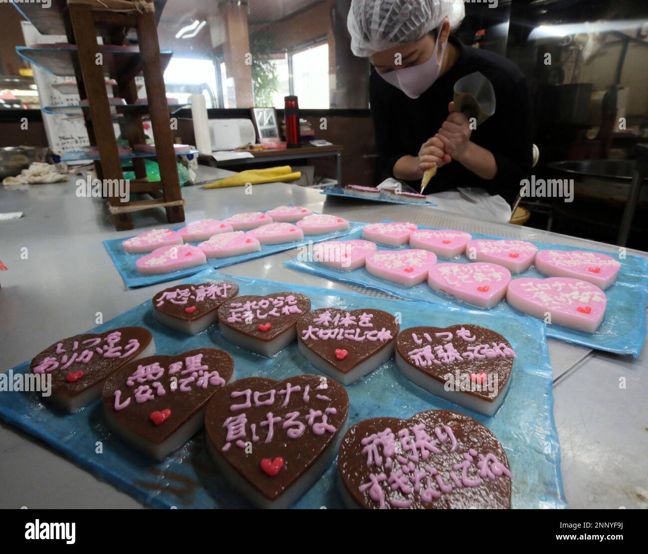 Heart-shaped kamaboko (boiled white fish paste) are made one after ...
