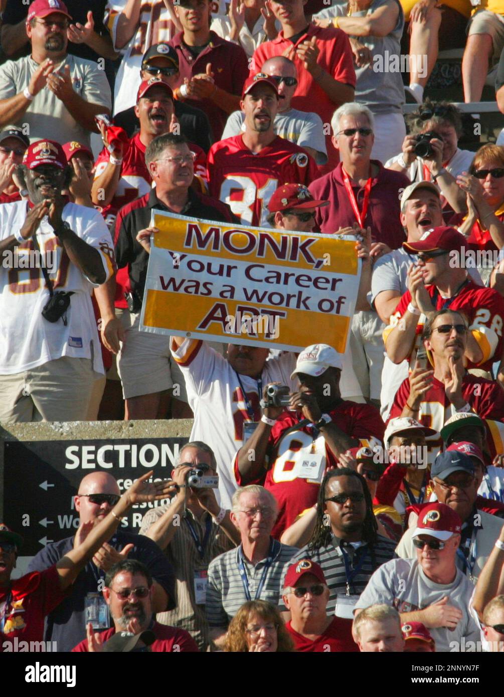 2 AUG 2008: An Art Monk holds up a sign to salute Art Monk before Monk ...