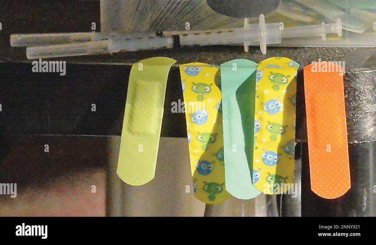 Adhesive bandages and syringes filled with the second dose of the ...