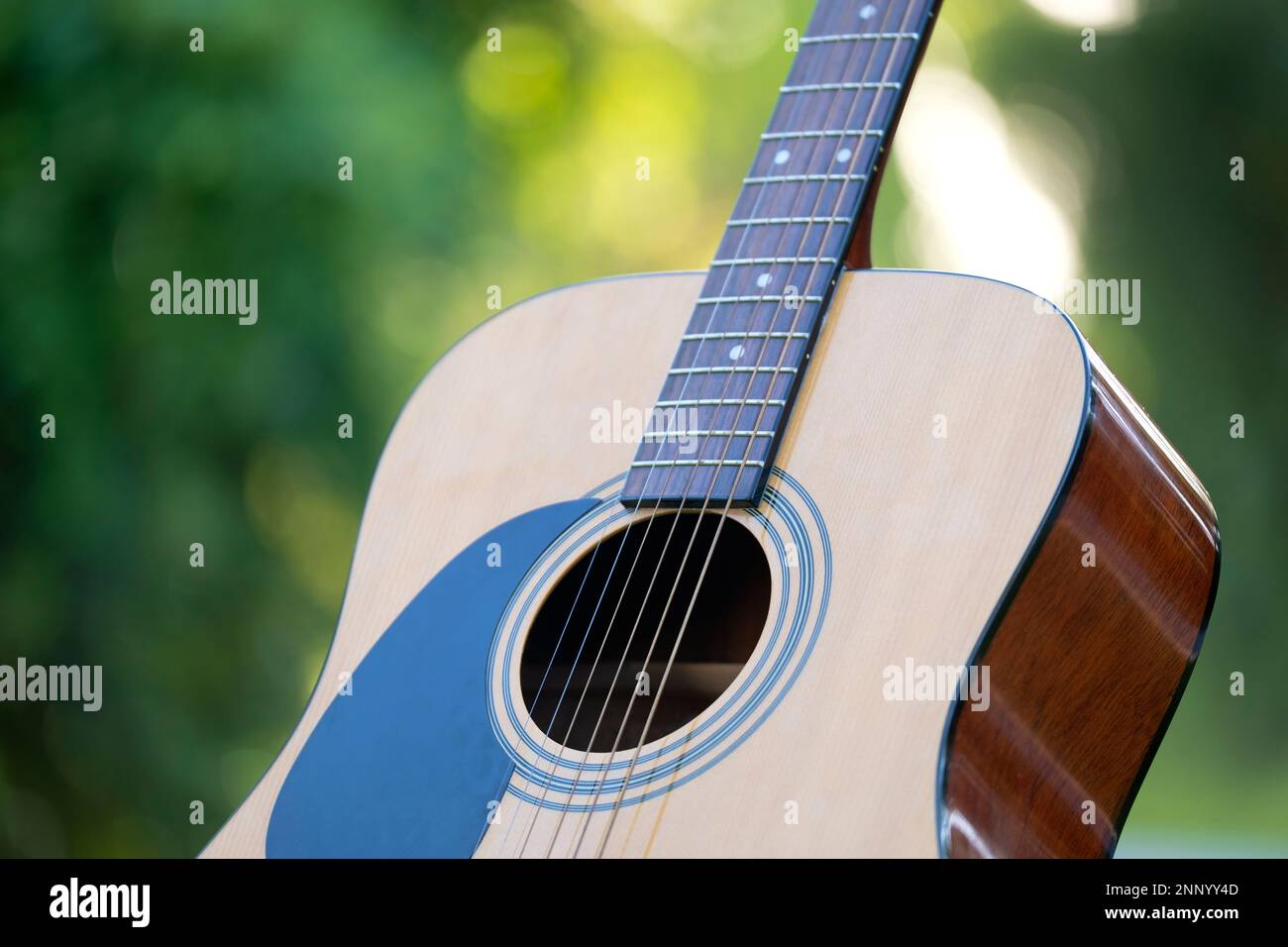 Acoustic guitar outdoors on greenery background. Concept of calm music ...