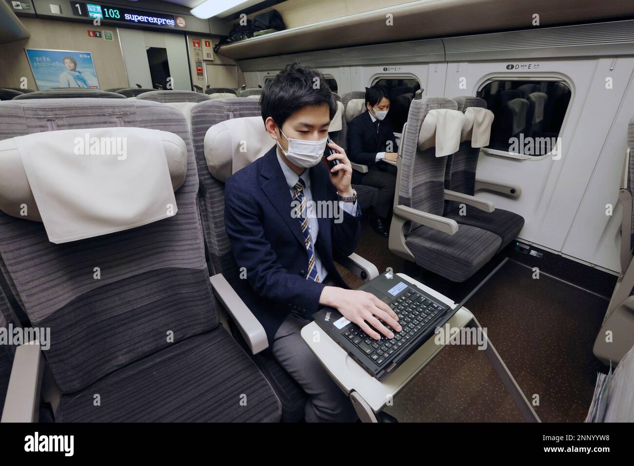 JR-East employee uses a mobile in a train of Shinkansen Bullet Train ...