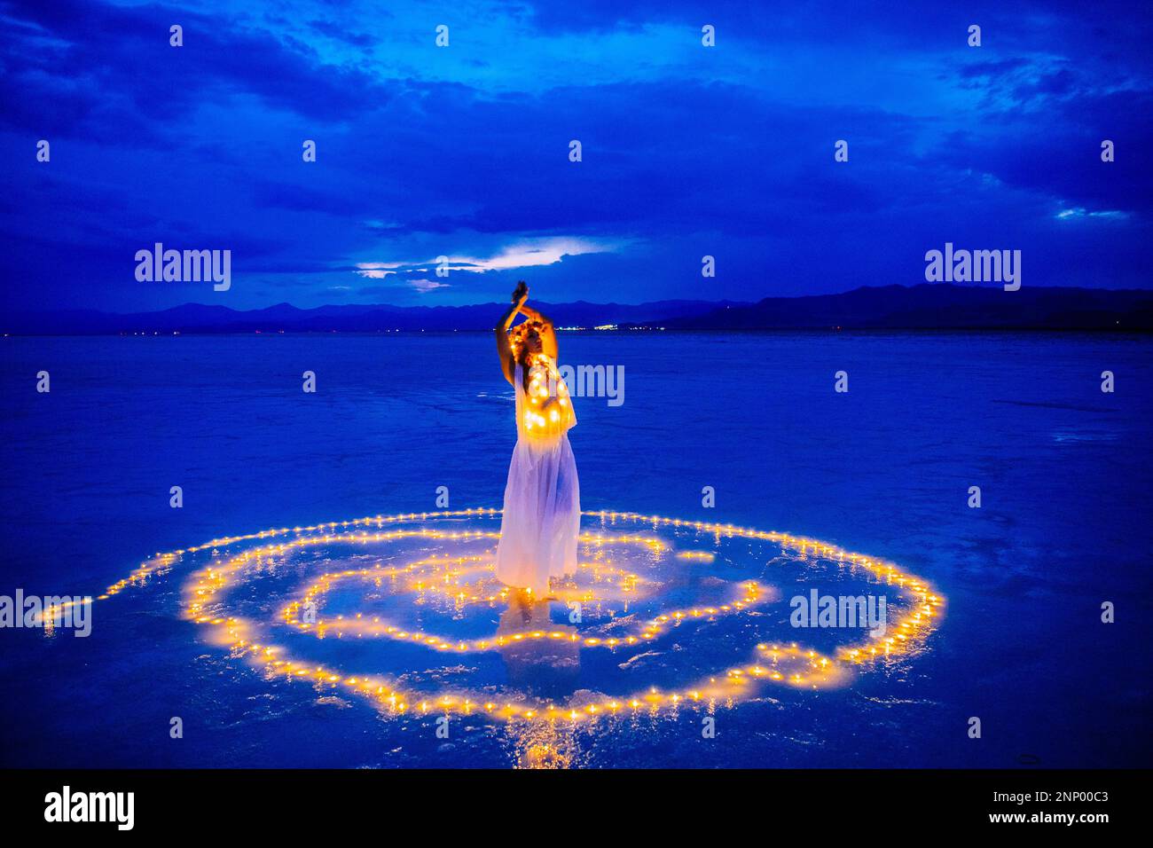 Female dancer surrounded by circle of light on water Stock Photo - Alamy