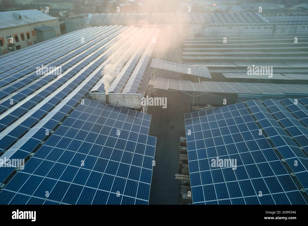 Aerial view of blue photovoltaic solar panels mounted on industrial ...
