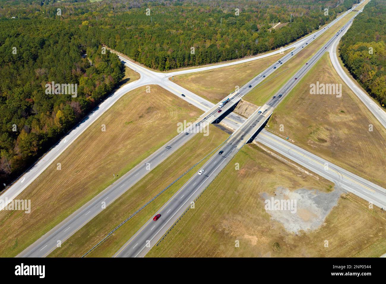 Aerial view of freeway overpass junction with fast moving traffic cars ...