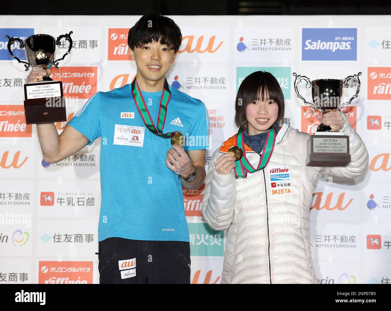 Kokoro Fujii (L) and Ai Mori pose with the championship trophy during ...