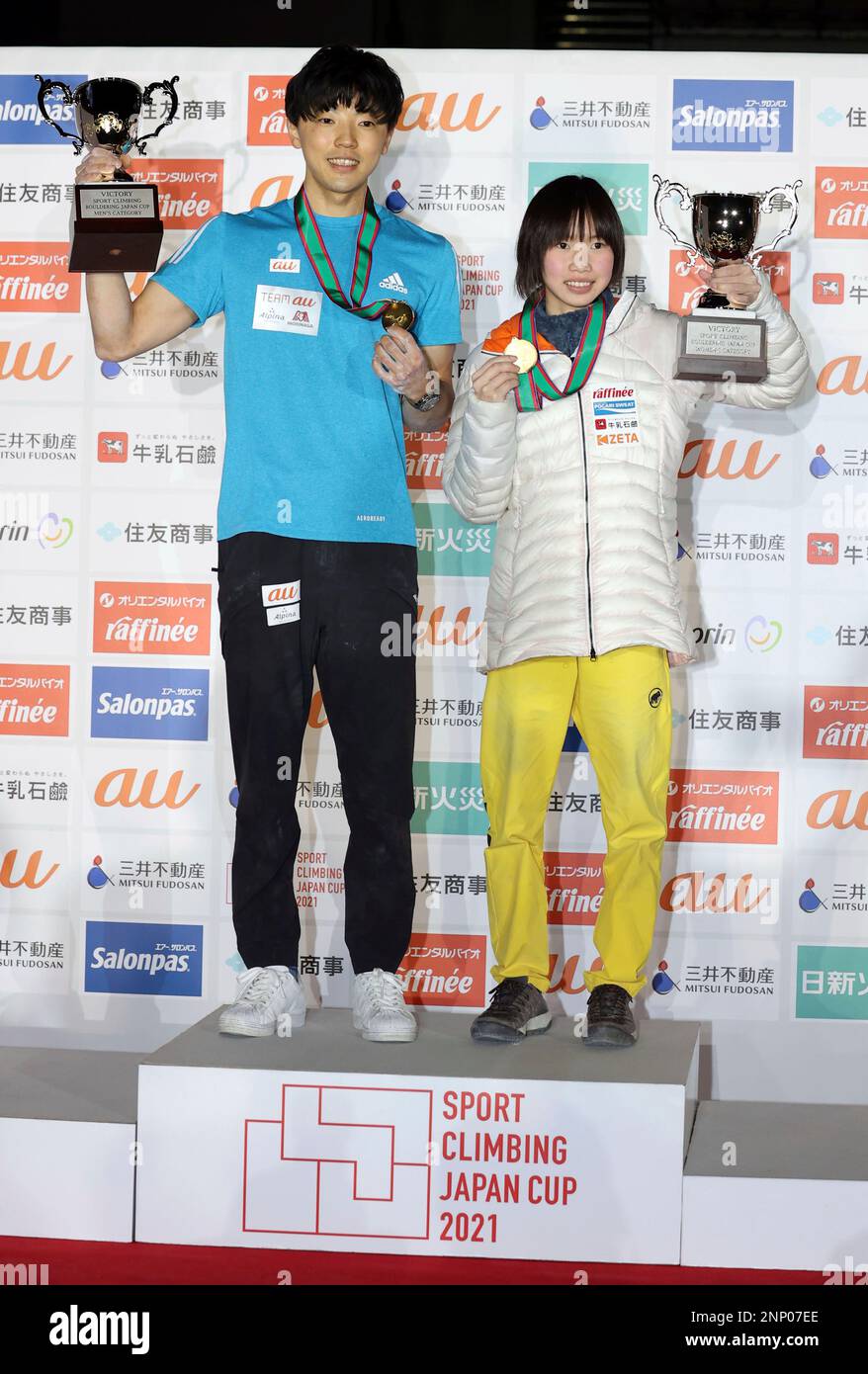 Kokoro Fujii (L) and Ai Mori pose with the championship trophy during ...