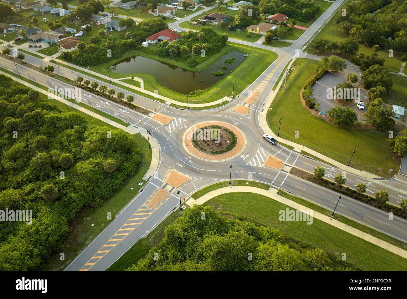 Aerial view of road roundabout intersection with moving cars traffic ...