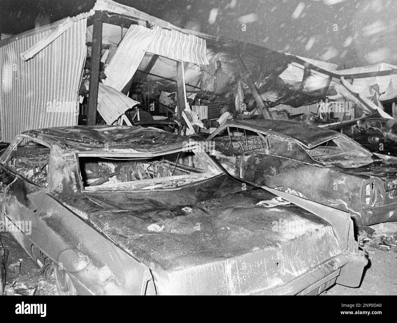 Cars lie smashed outside Thiokol Plant, left, and building is destroyed ...