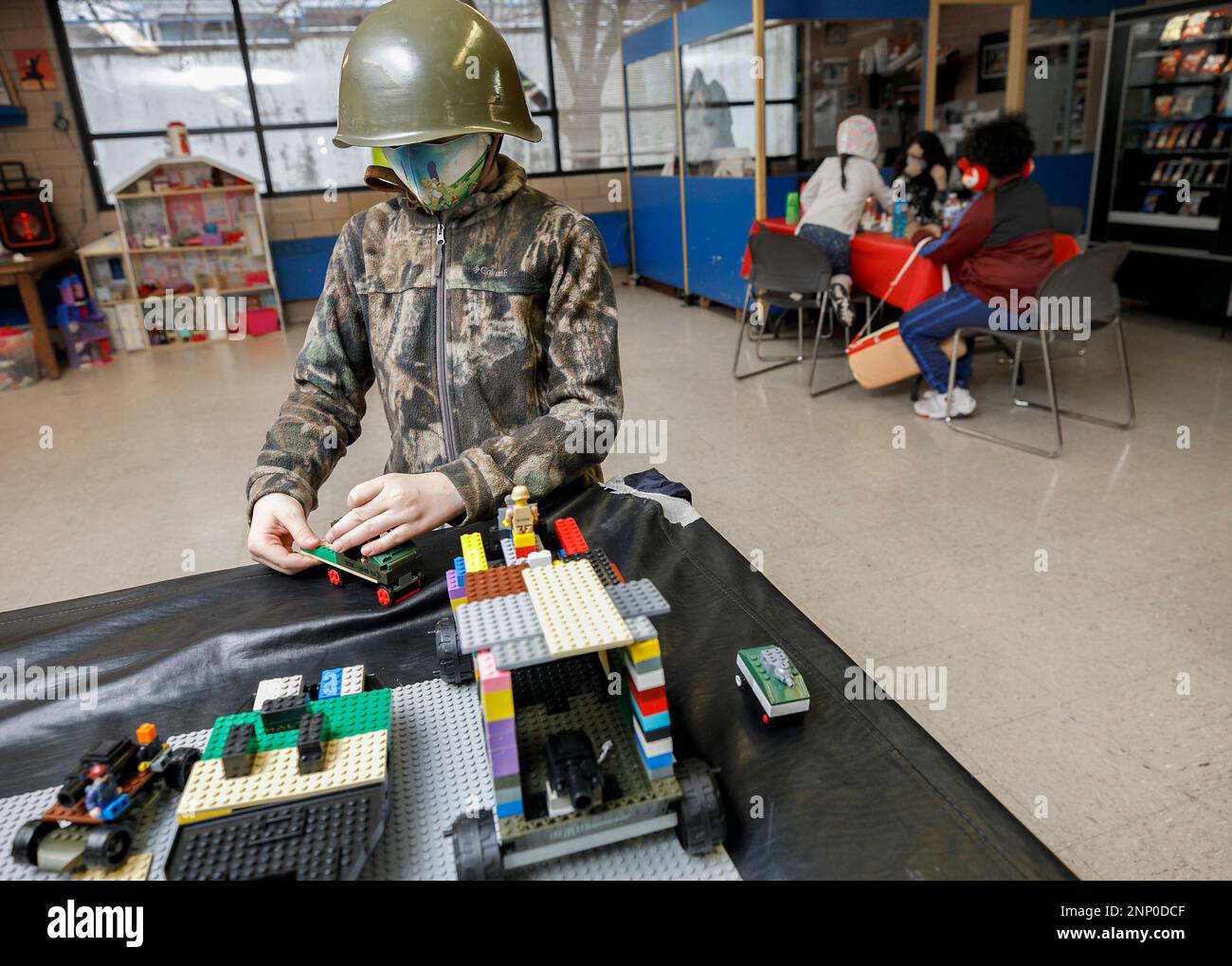 Vincenzo Ferrera, 9, of Meriden, wears a combat helmet while building a ...