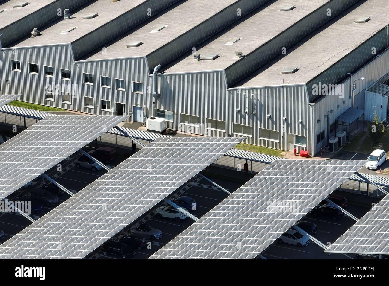 Aerial view of solar panels installed over parking lot with parked cars ...