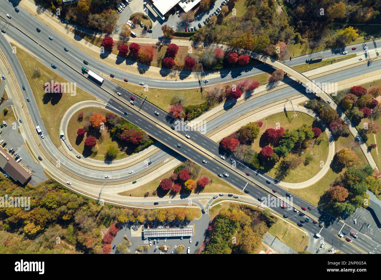 American freeway intersection with fast driving cars and trucks. View ...