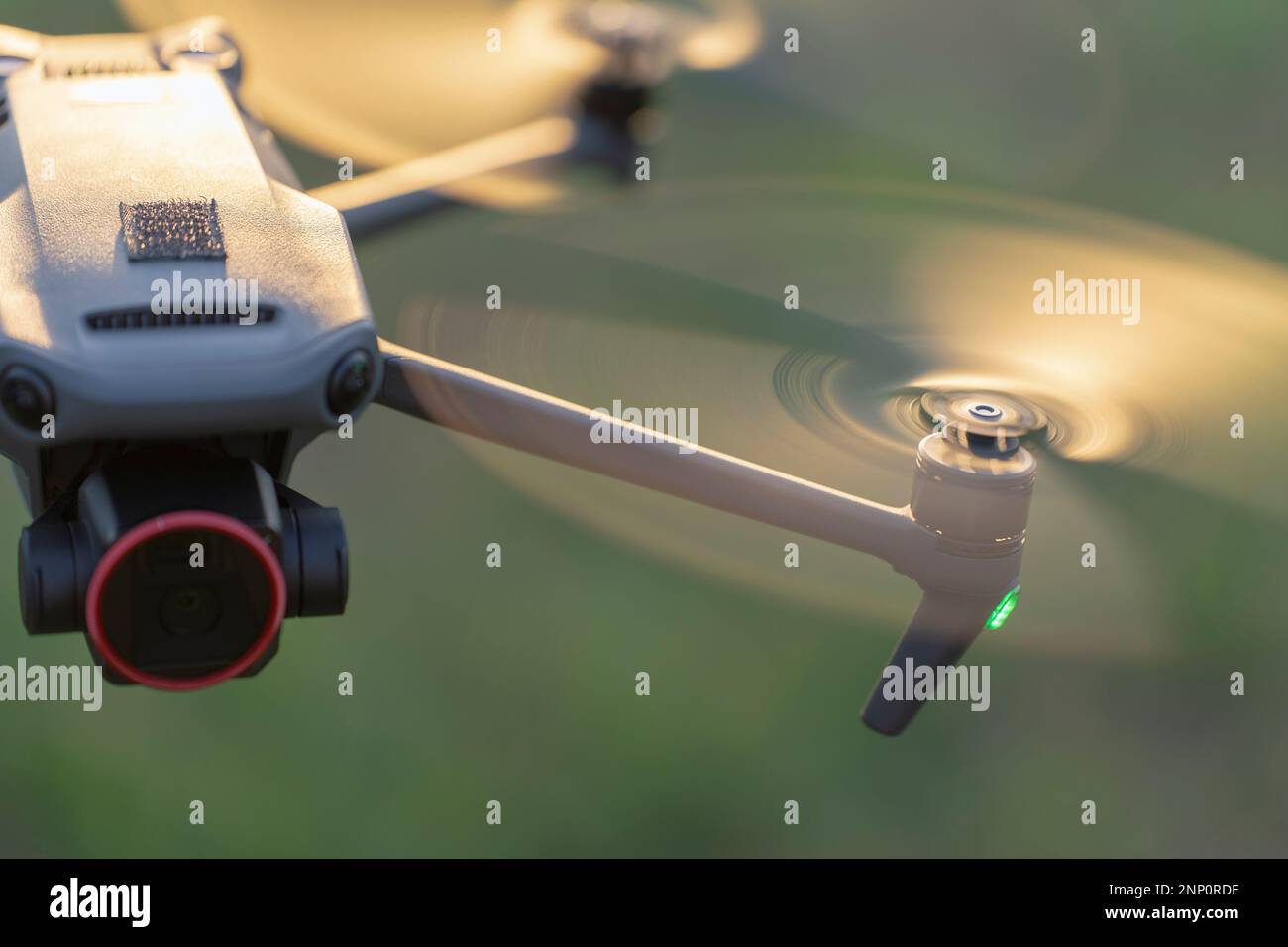 Drone aircraft with blurred fast rotating propellers and video camera ...