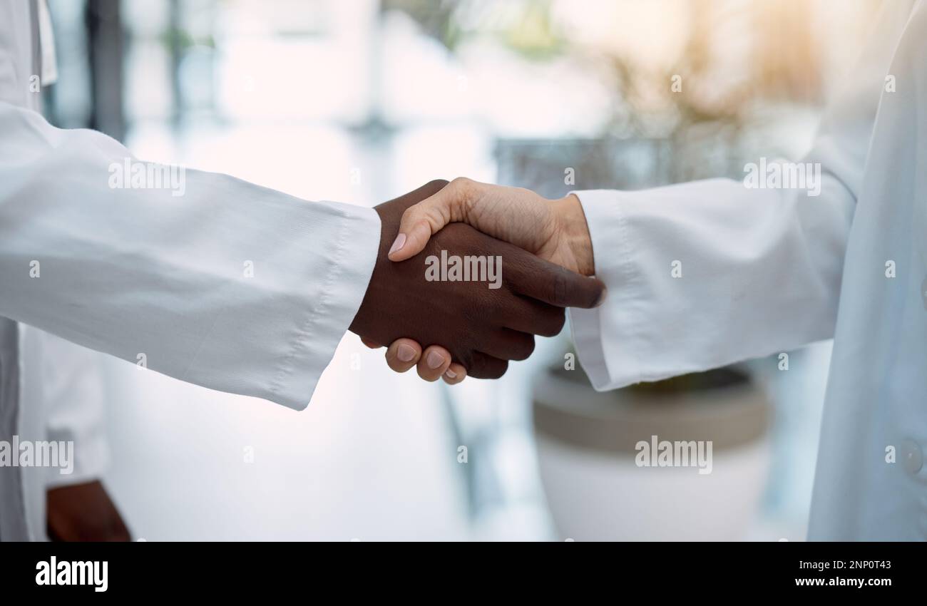 Doctor, handshake and partnership in healthcare, agreement or deal for ...