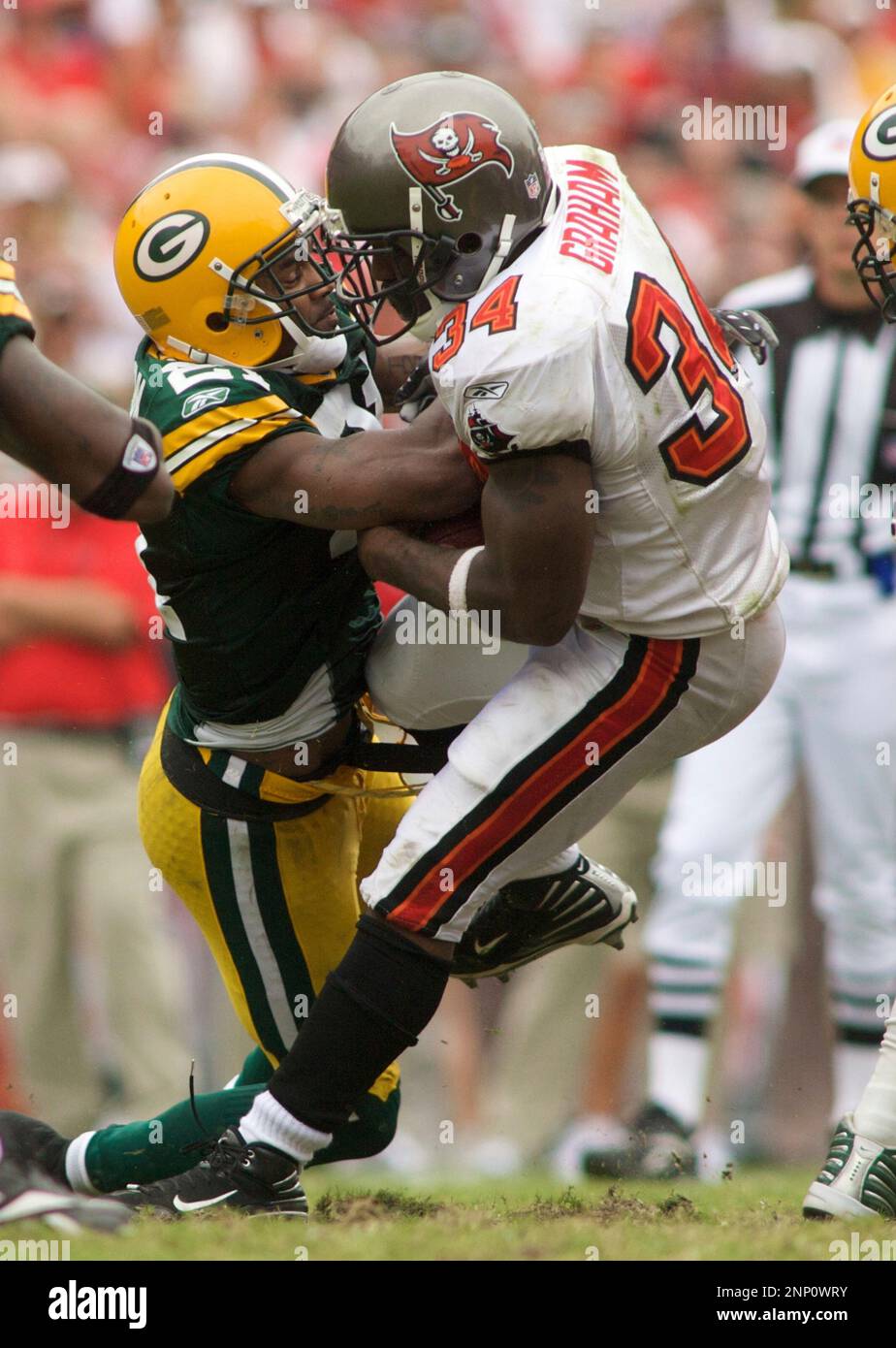 Green Bay Packers cornerback Charles Woodson (21) tackles Tampa Bay ...