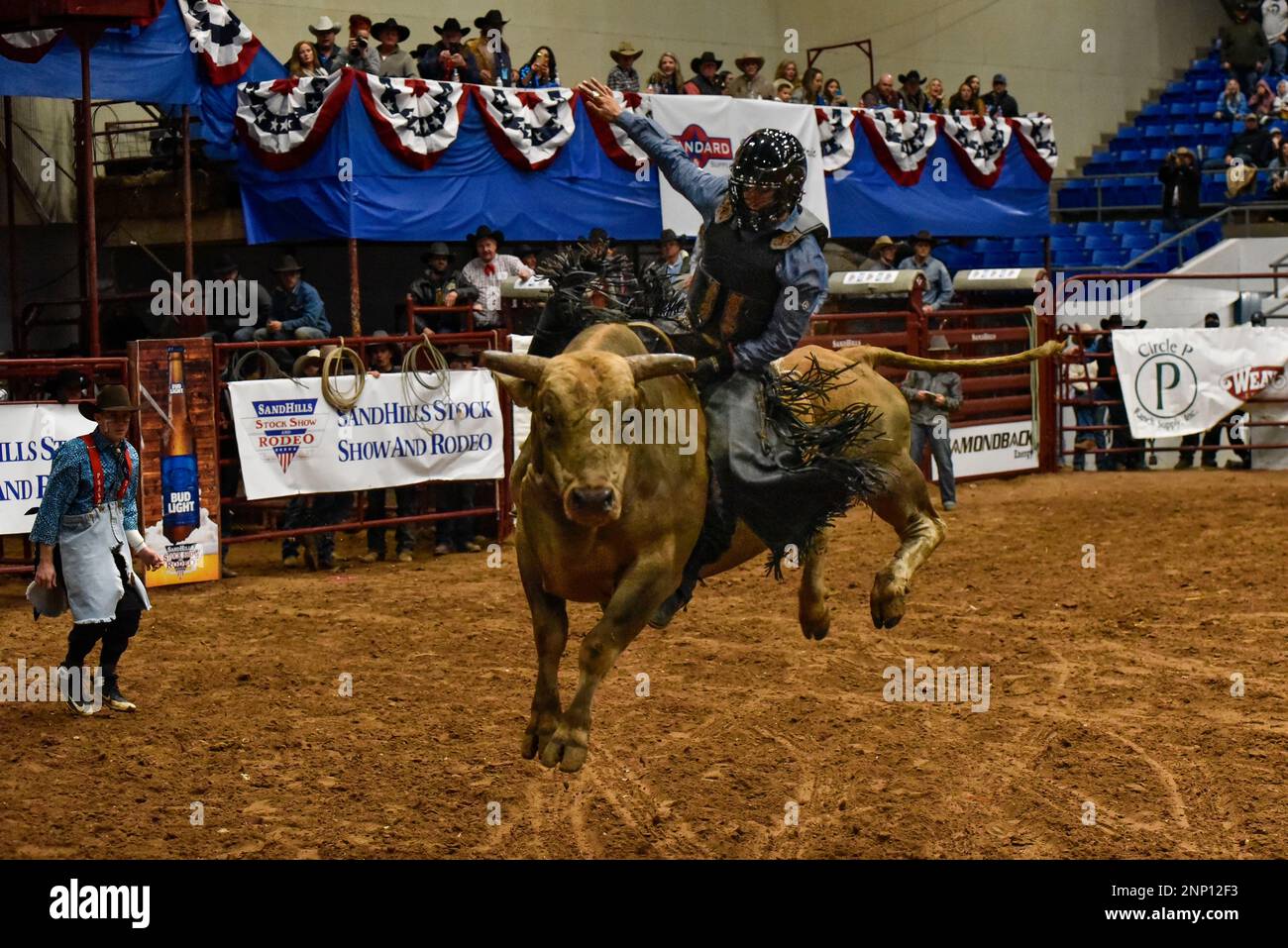 Elijah Mora of Wiggins, Colo., holds on to the bull "Rim Rock" as he ...