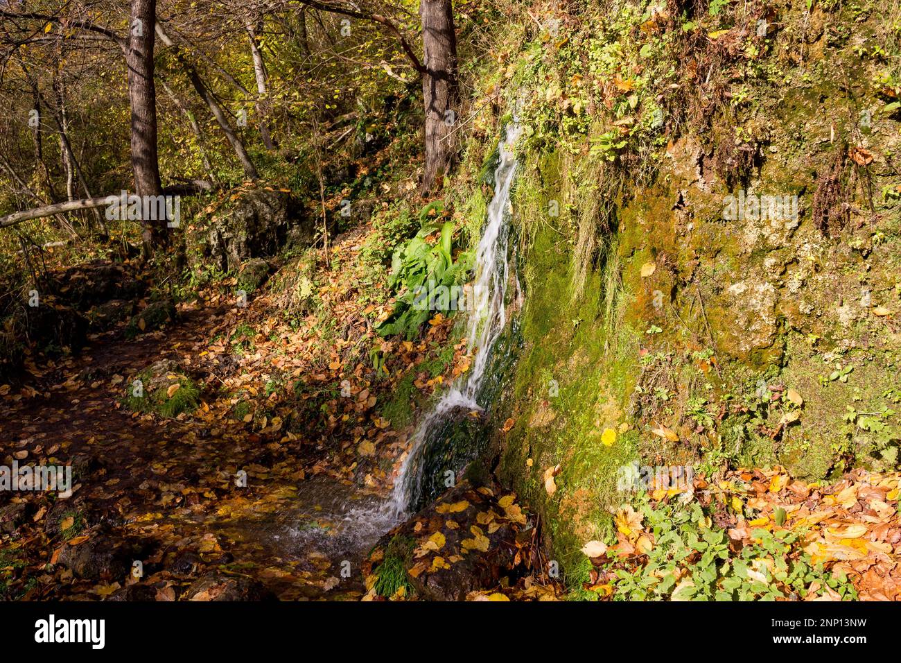 A picturesque small Raduzhnyi waterfall in the suburbs against the ...