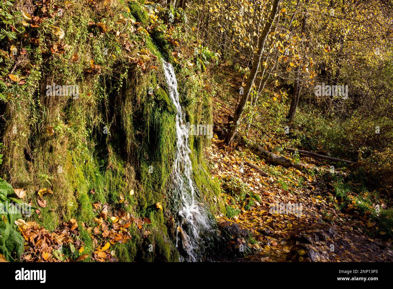 A picturesque small Raduzhnyi waterfall in the suburbs against the ...