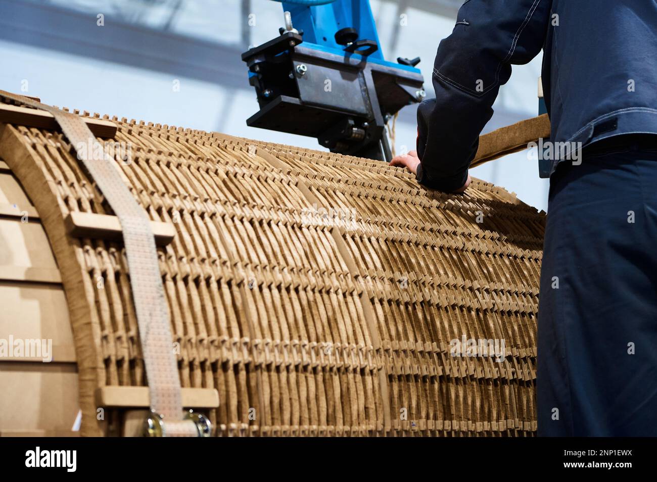 Worker wraps insulation fabric onto transformer core Stock Photo - Alamy