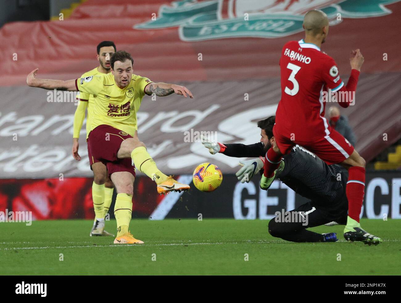 Liverpool's goalkeeper Alisson saves a shot by Burnley's Ashley Barnes ...