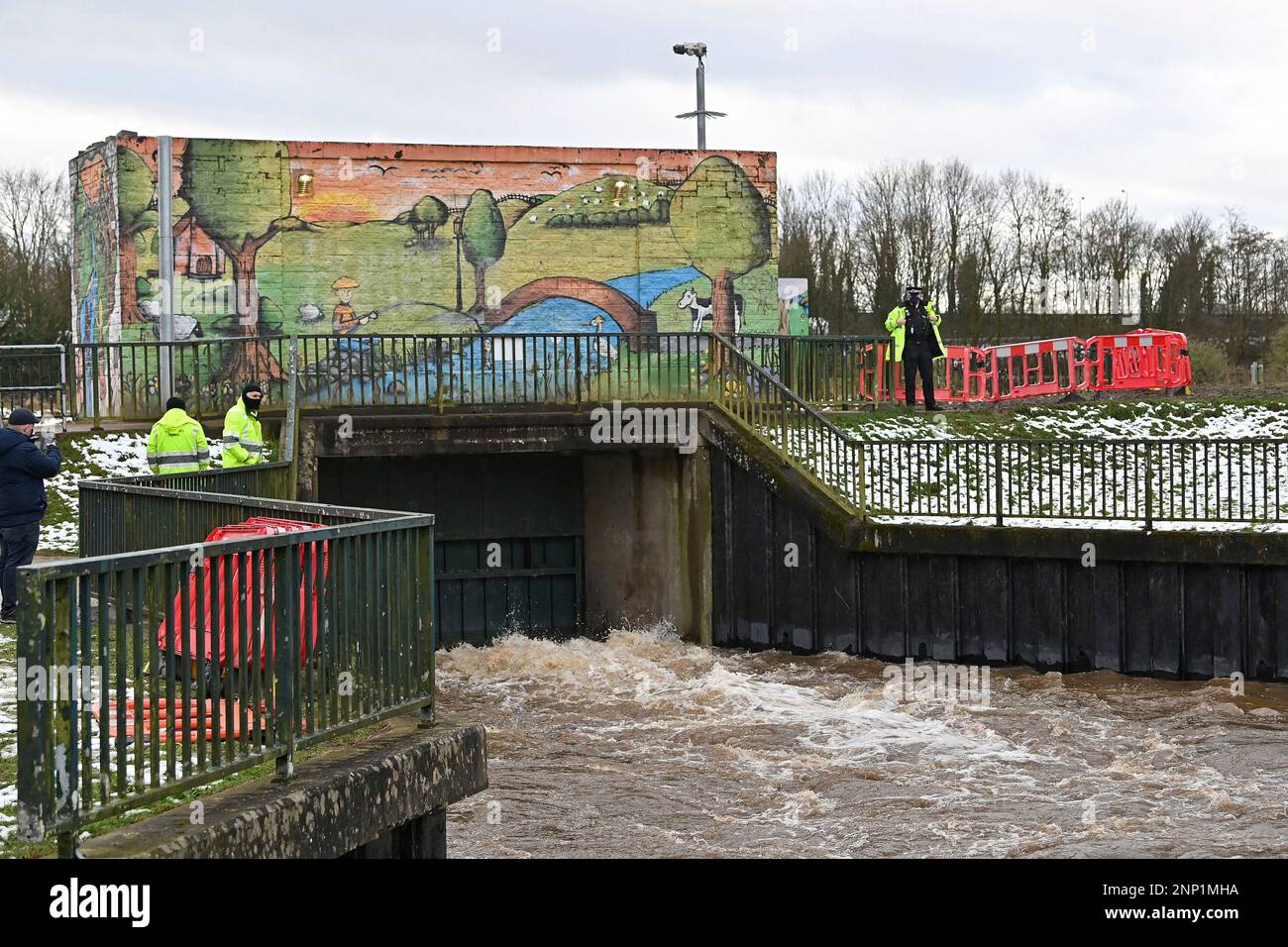 Environment Agency workers flood a storm basin near the River Mersey in ...