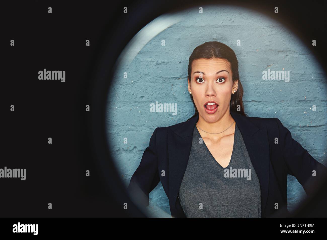 Say whaaat. Portrait of a businesswoman posing against a brick wall ...