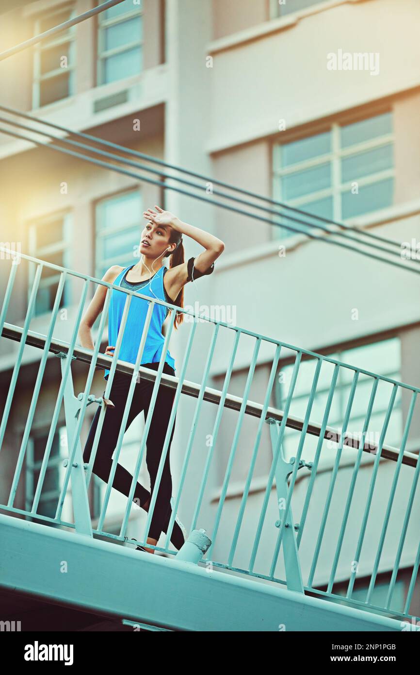 Run till you sweat. a young woman looking exhausted during her morning ...