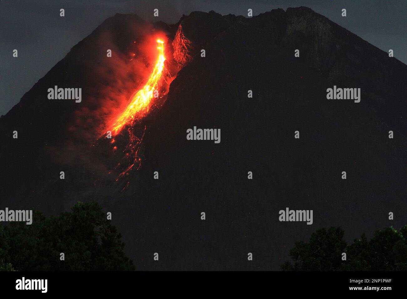 Hot lava flows down from the crater of Mount Merapi as its activity ...