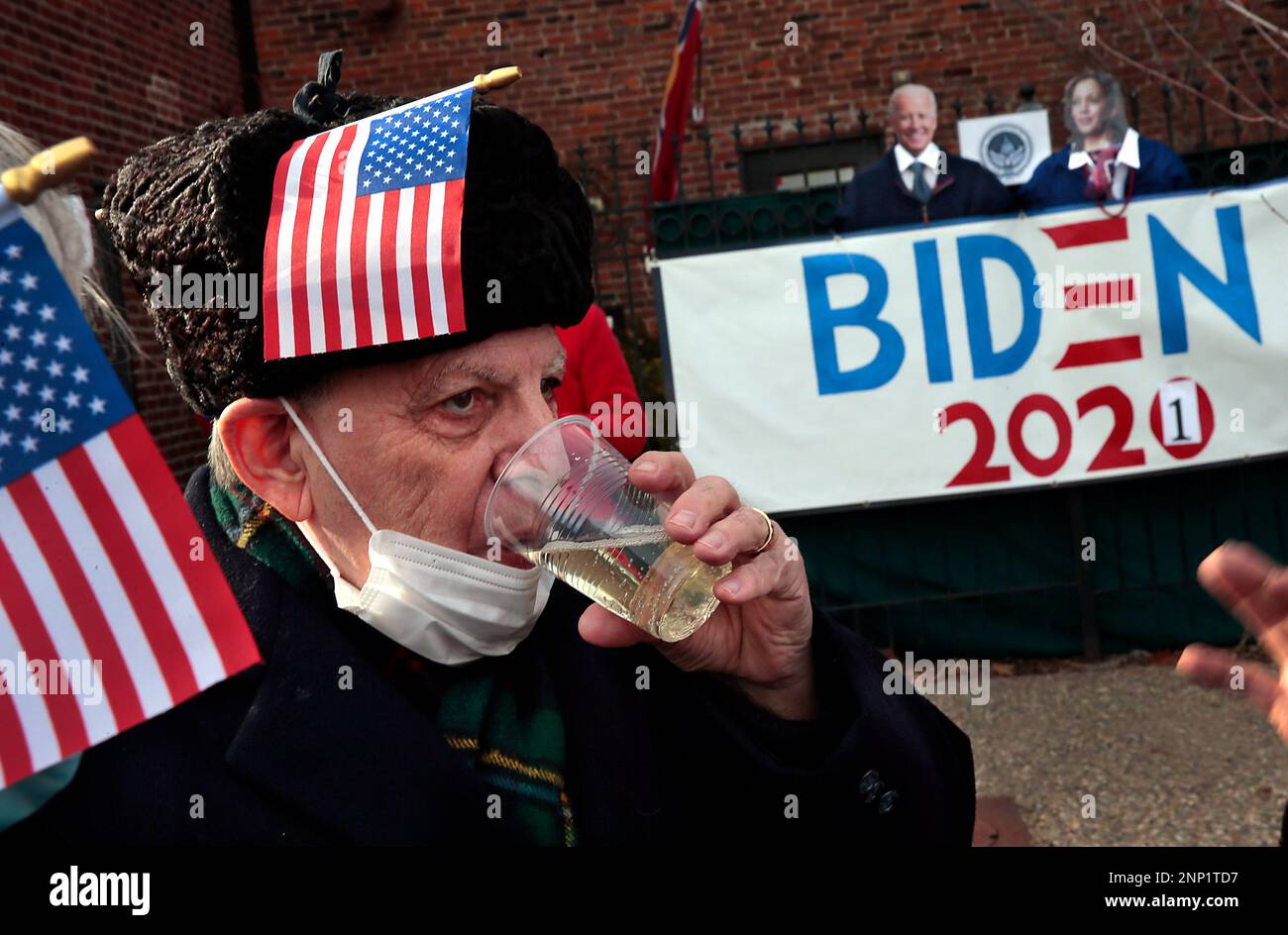 Tom Keay, left, toasts incoming President Joe Biden and Vice-President ...