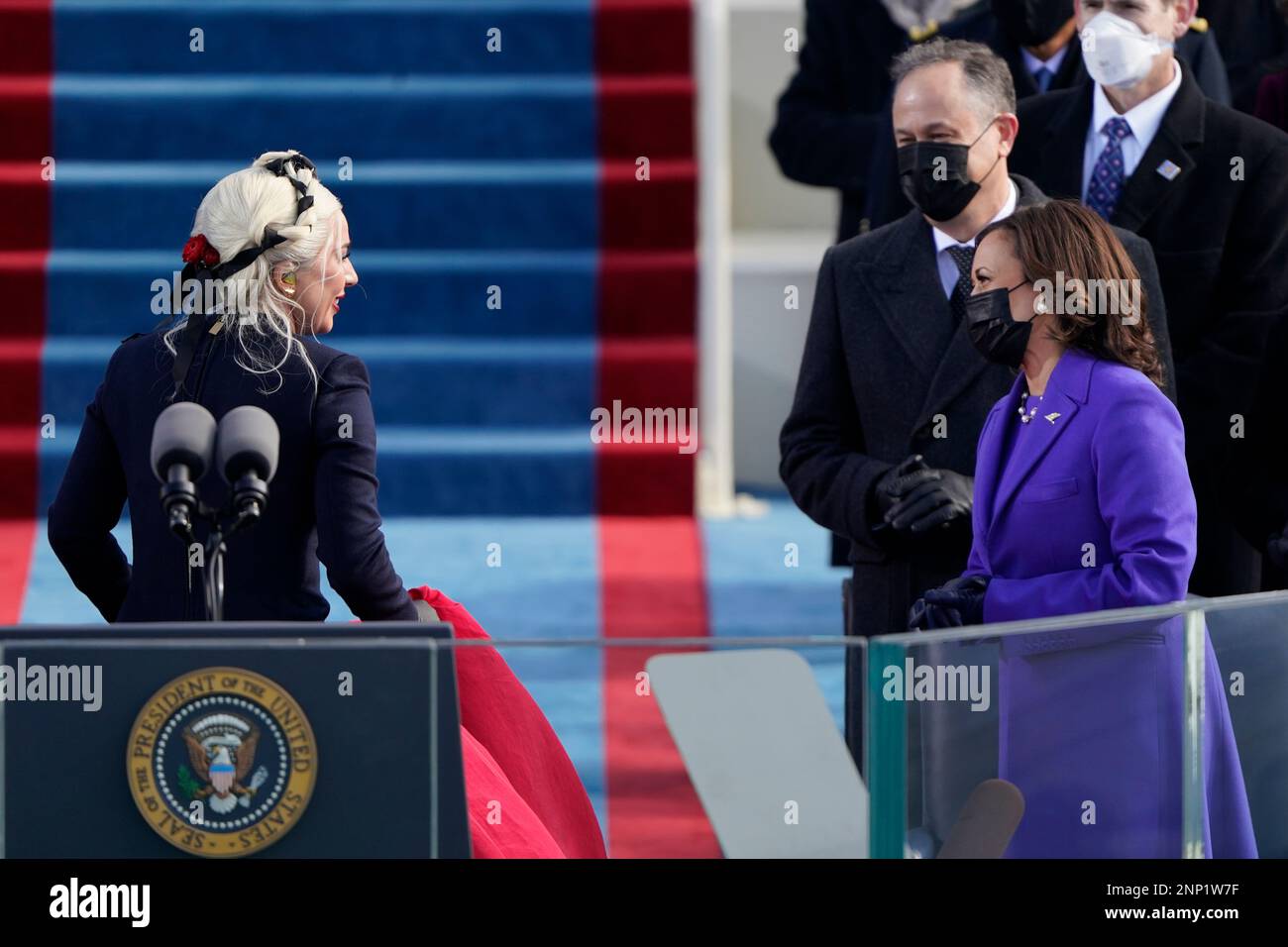 Lady Gaga talks to Vice President-elect Kamala Harris after singing the ...