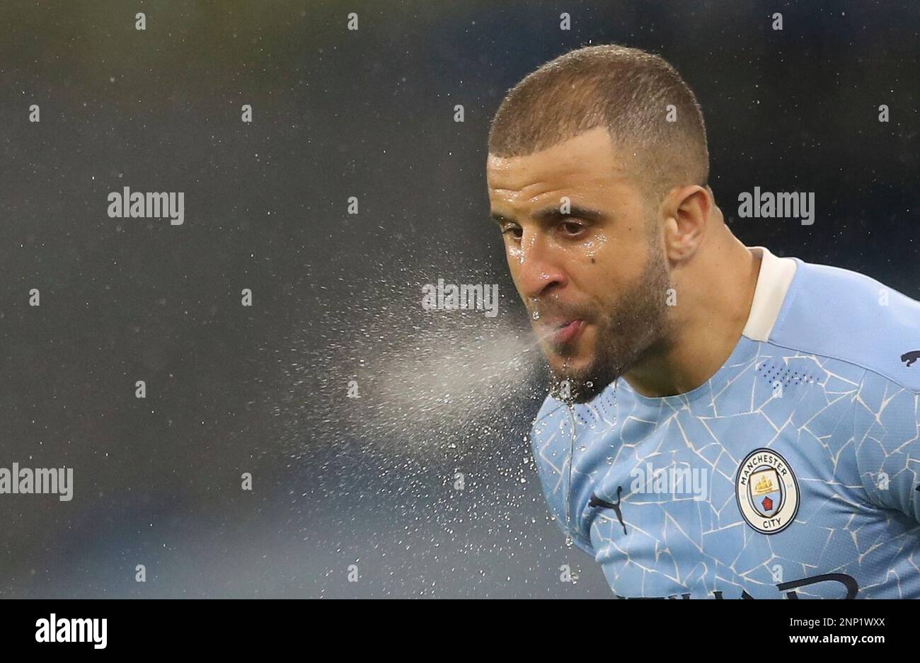 Manchester City's Kyle Walker spits out water before the English ...